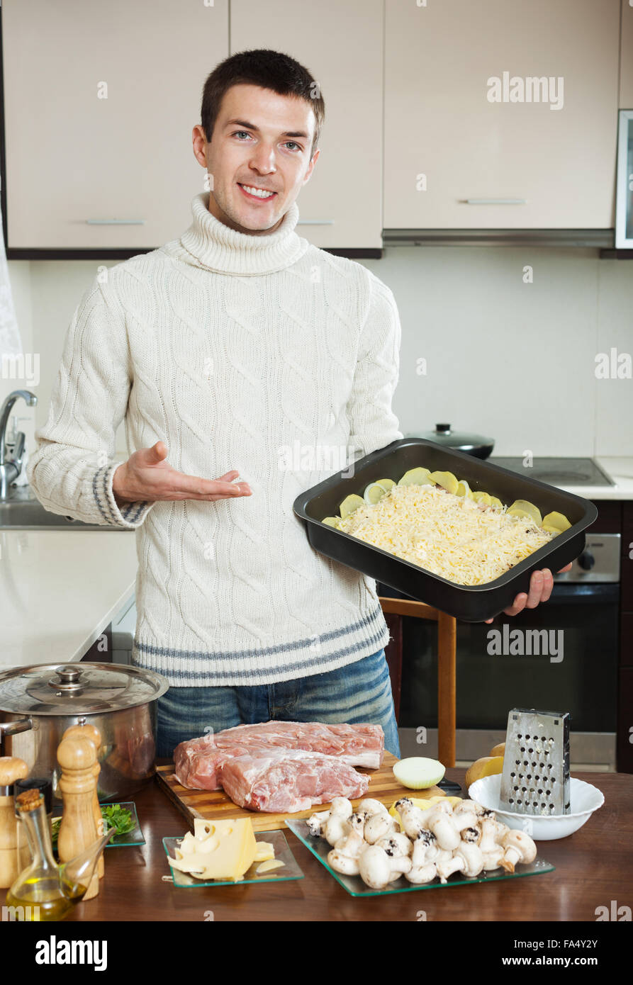 Handsome man Cooking french-style veal- cutting potatoes Stock Photo ...