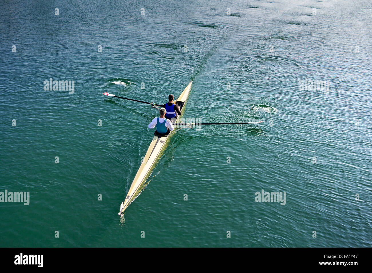 Two Man in a boat, rowing on the tranquil lake Stock Photo - Alamy