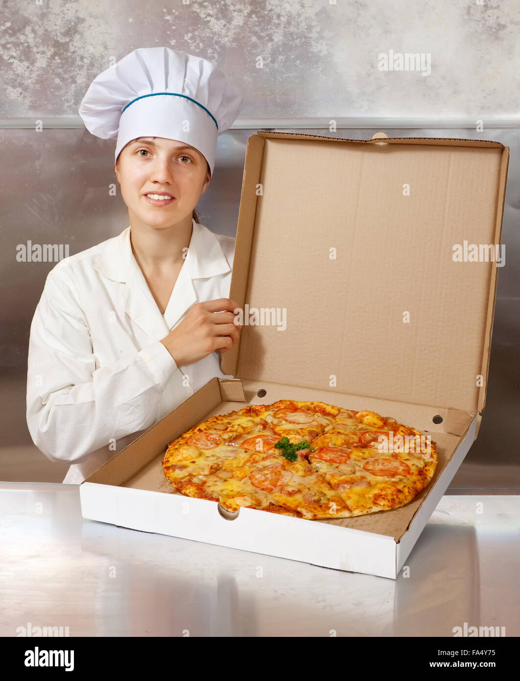 female cook with fresh pizza in box at kitchen Stock Photo - Alamy