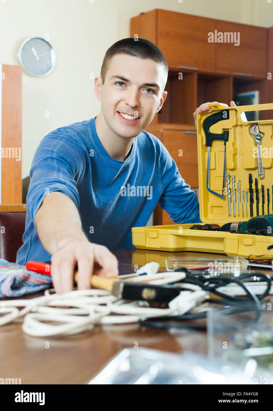 young man doing something with working tools in home Stock Photo - Alamy