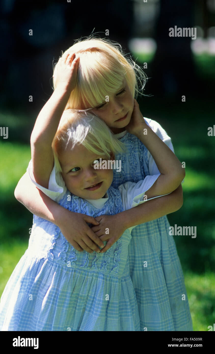 Blonde sisters hugging hi-res stock photography and images - Alamy