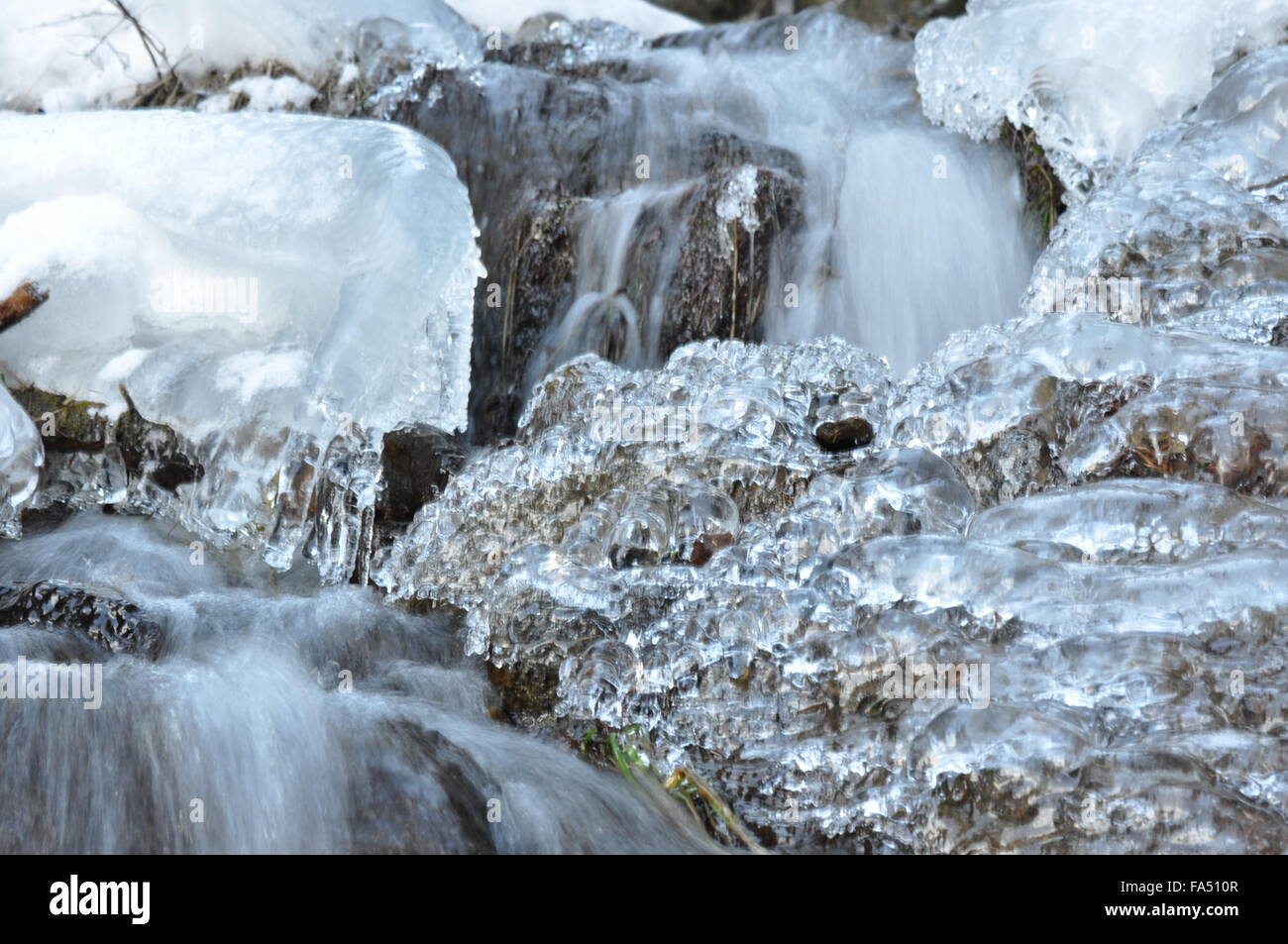 Water running down frozen stream Stock Photo - Alamy