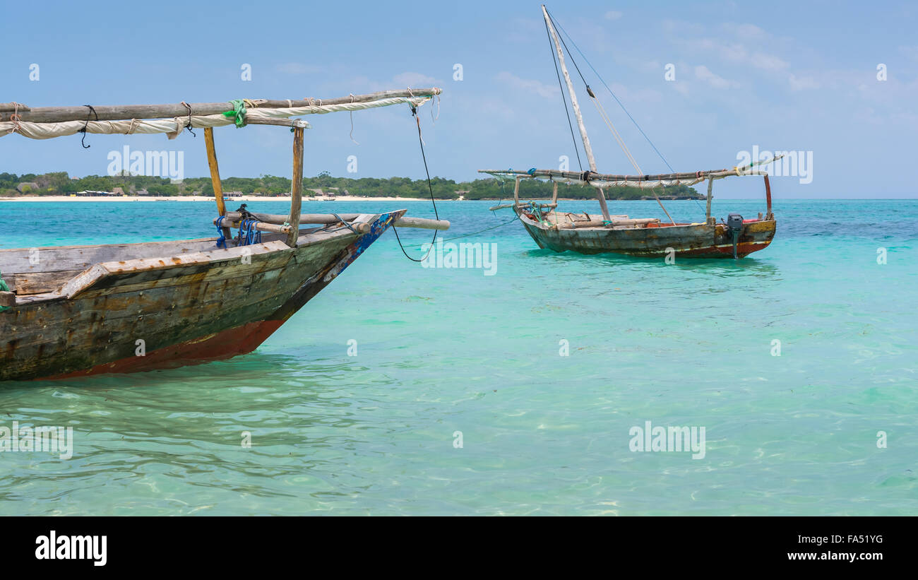 Anchored wooden dhow boats on the amazing turquoise water in the Indian ...