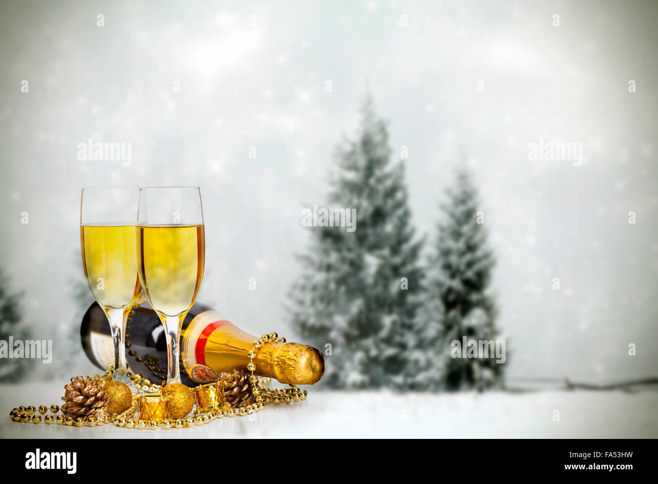 Glasses and bottle of champagne on winter landscape background Stock ...