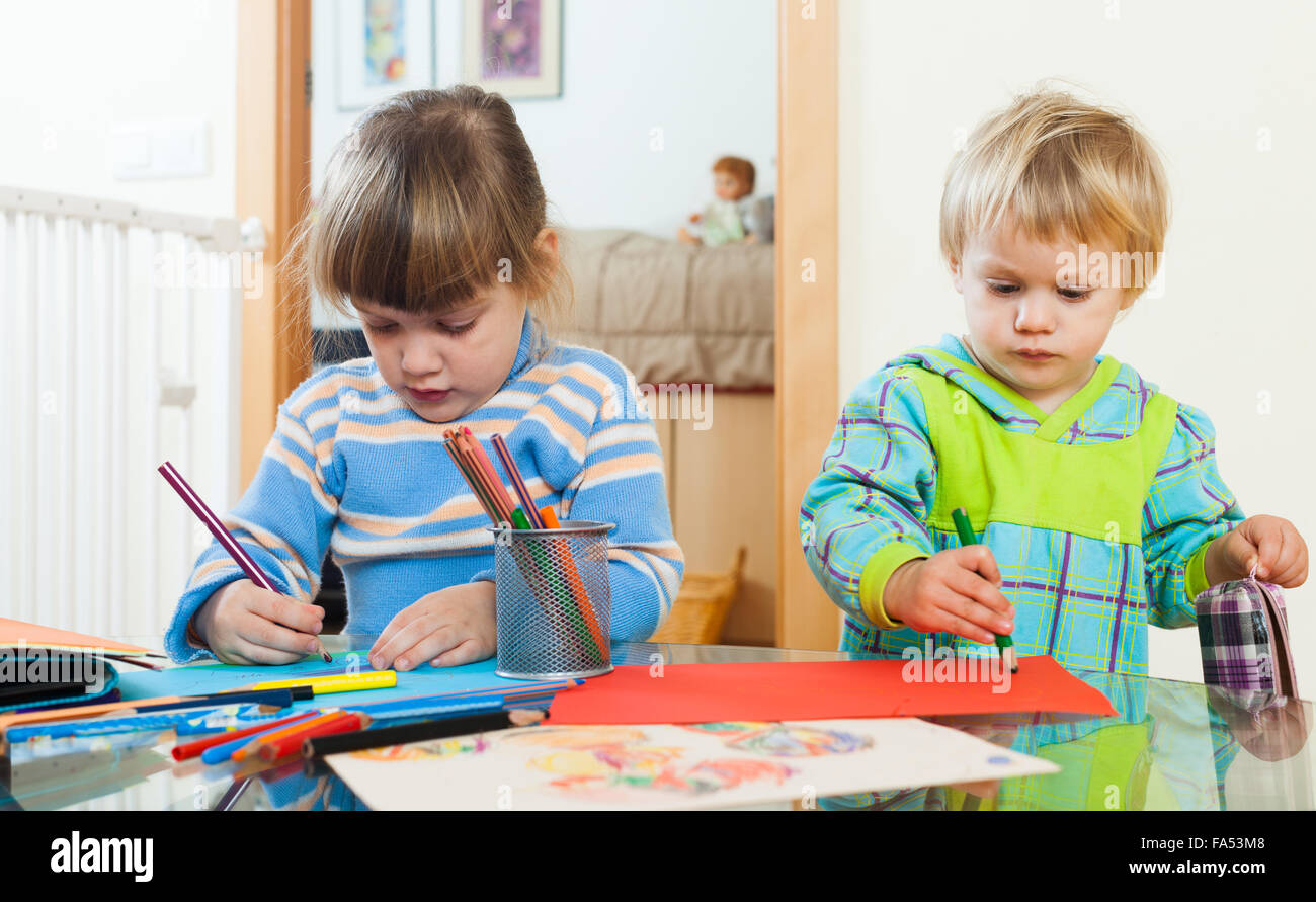 serious children drawing with paper and pencils in home Stock Photo - Alamy