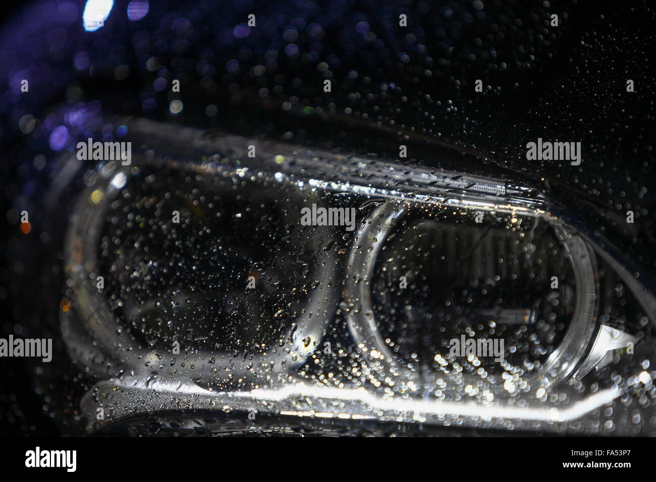 Color image of a car's headlight, covered with rain drops Stock Photo ...