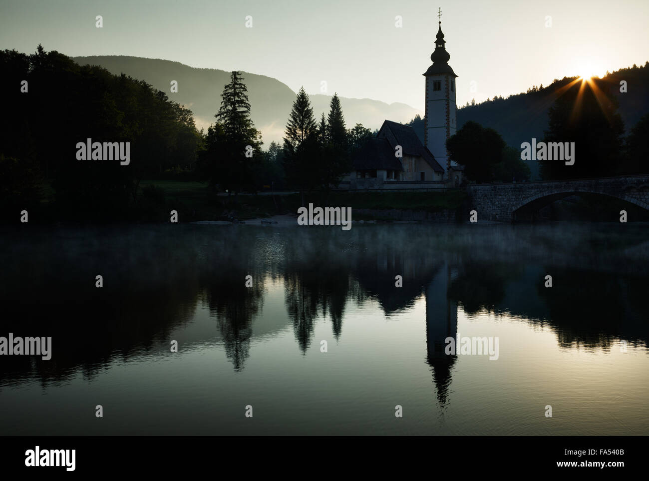Sun rising over the hills behind the Church of Saint John (Sveti Janez ...