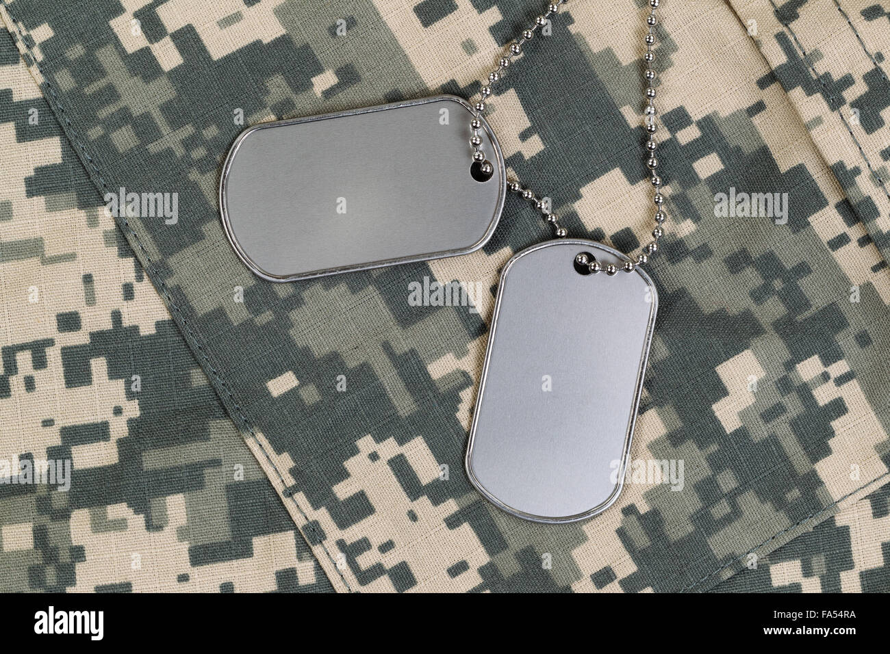 Military identification tags, neck chain, and combat uniform top ...