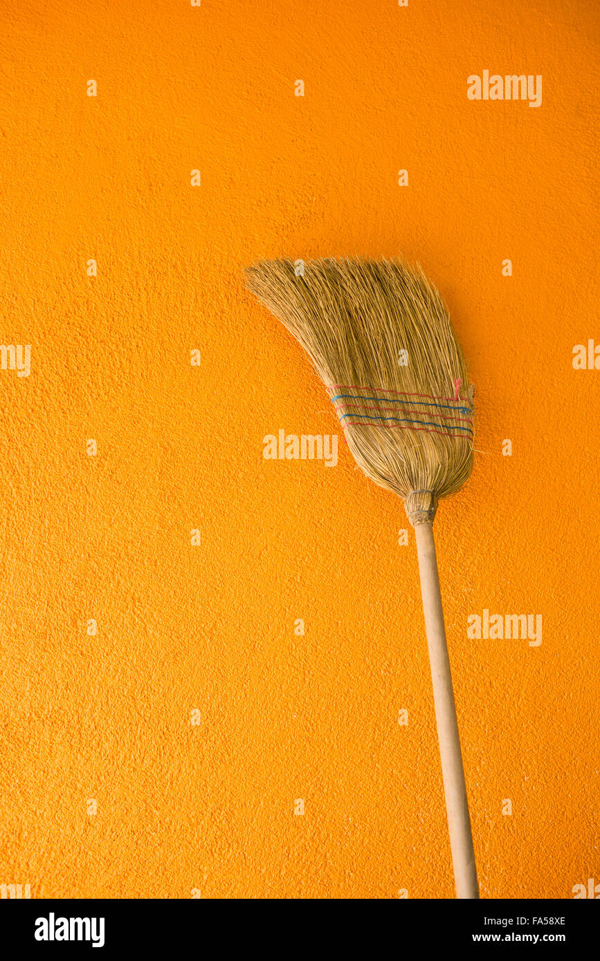 Broom leaning against yellow wall, Austria Stock Photo - Alamy