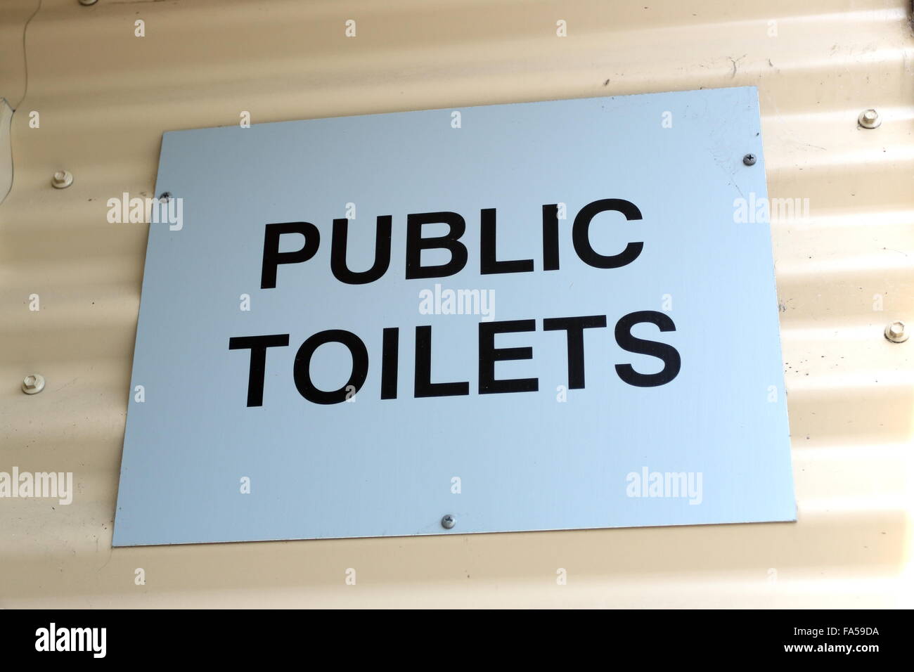Public Toilets signboard on the wall Stock Photo - Alamy