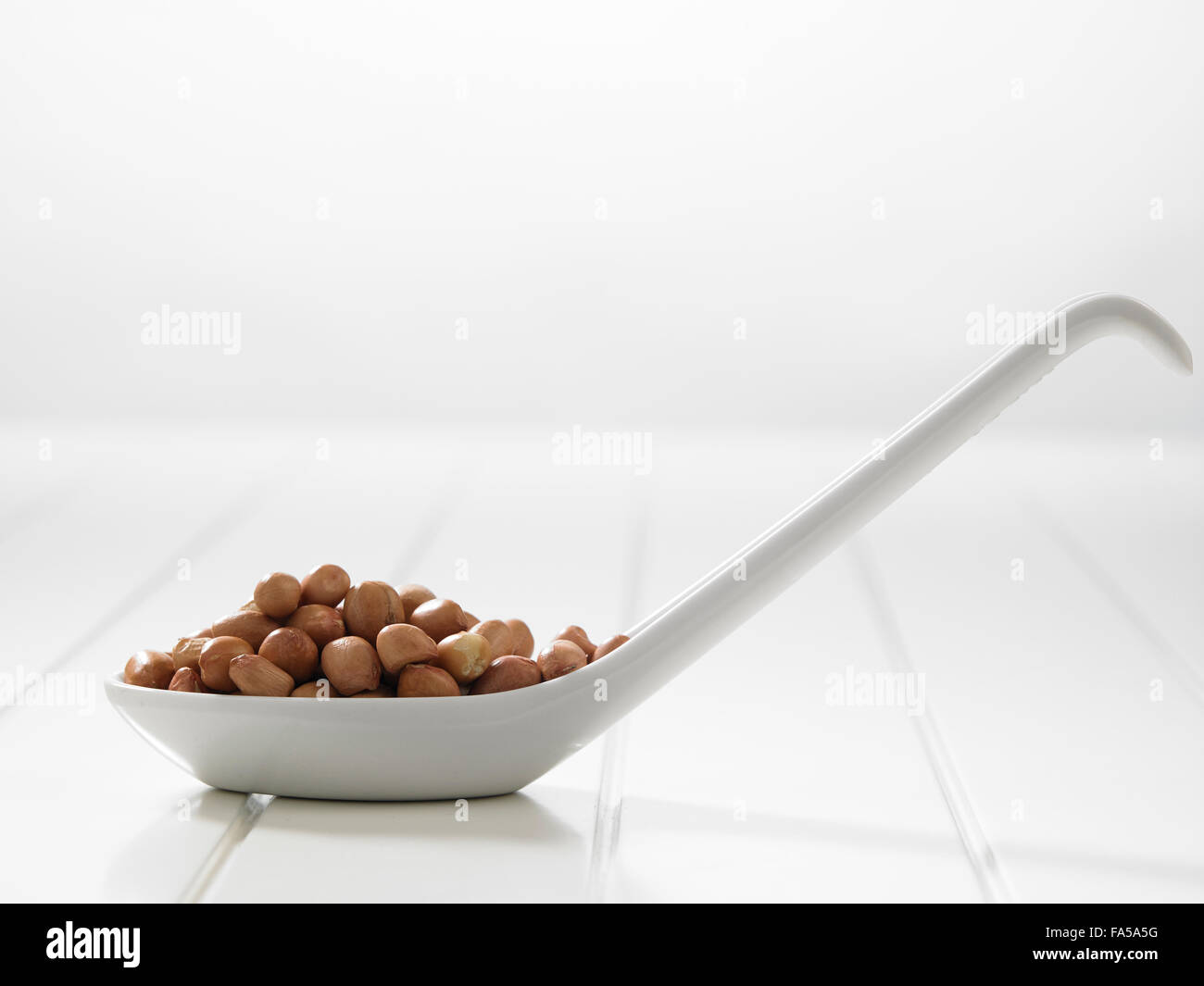 spoon full of ground nuts Stock Photo - Alamy