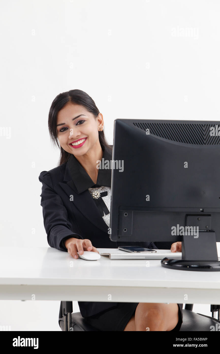 business woman sitting in front monitor looking at camera Stock Photo ...
