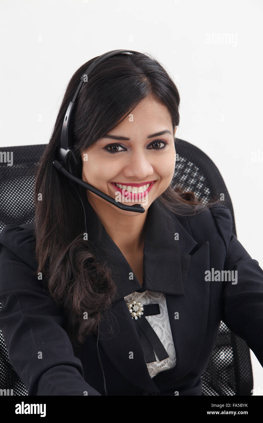 beatiful receptionist wearing head set talking Stock Photo - Alamy