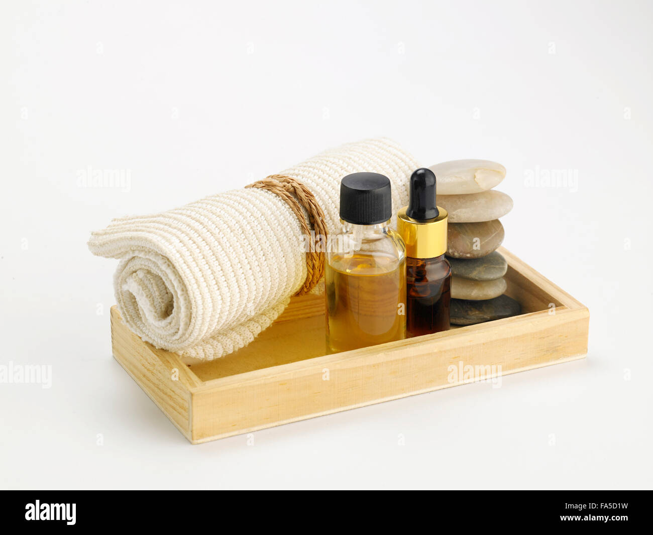 spa concept of massage oil and towel in a wooden container Stock Photo ...