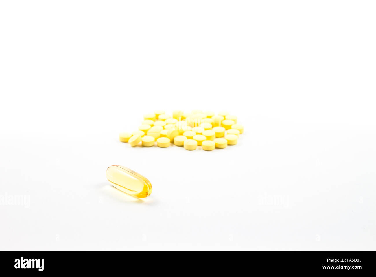 Fish oil capsule and yellow pills isolated on white background, stock ...
