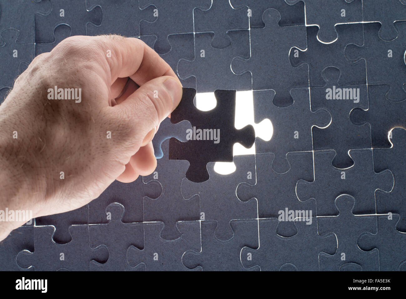 Missing jigsaw puzzle piece with light glow Stock Photo - Alamy