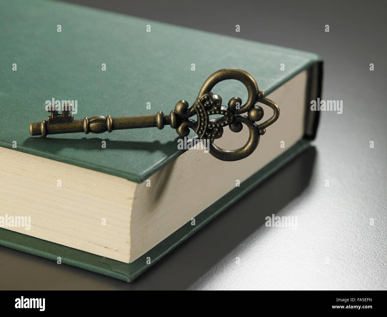 retro golden key on thick hard cover book Stock Photo - Alamy