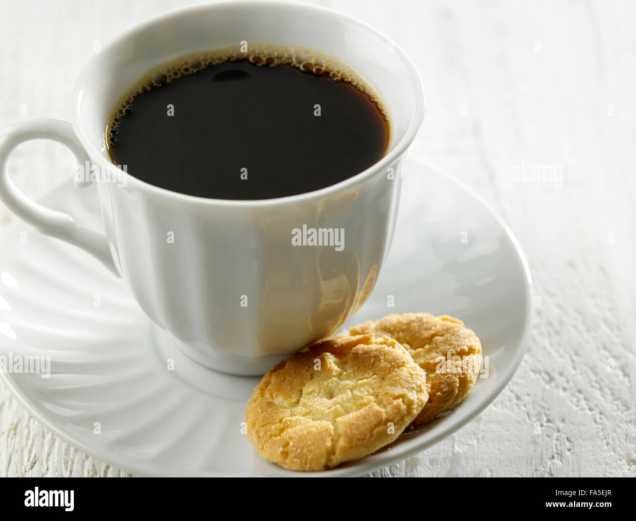 black coffee with two biscuits Stock Photo - Alamy