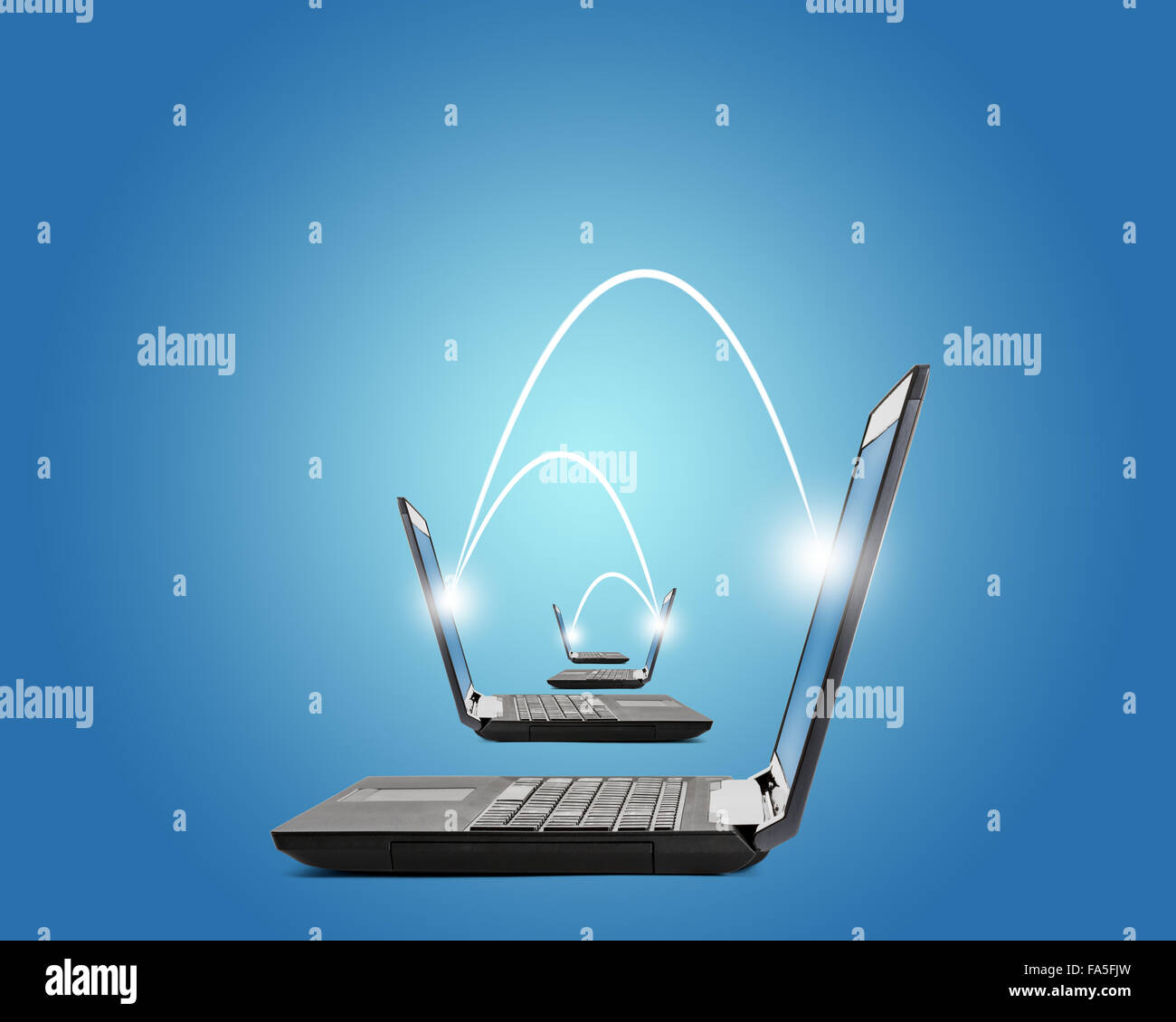 Connected laptops on blue Stock Photo - Alamy