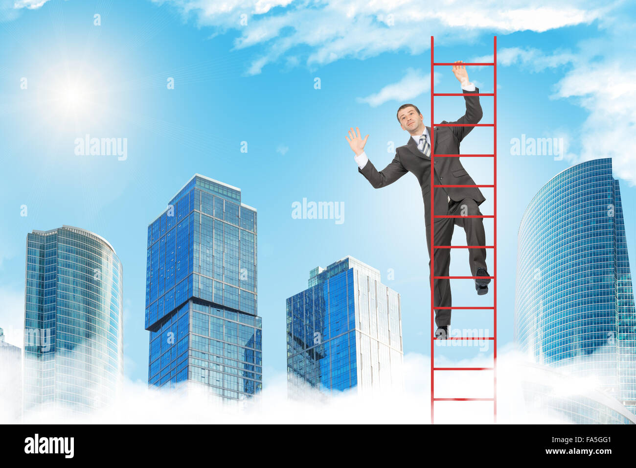 Happy businessman climbing ladder in sky Stock Photo - Alamy