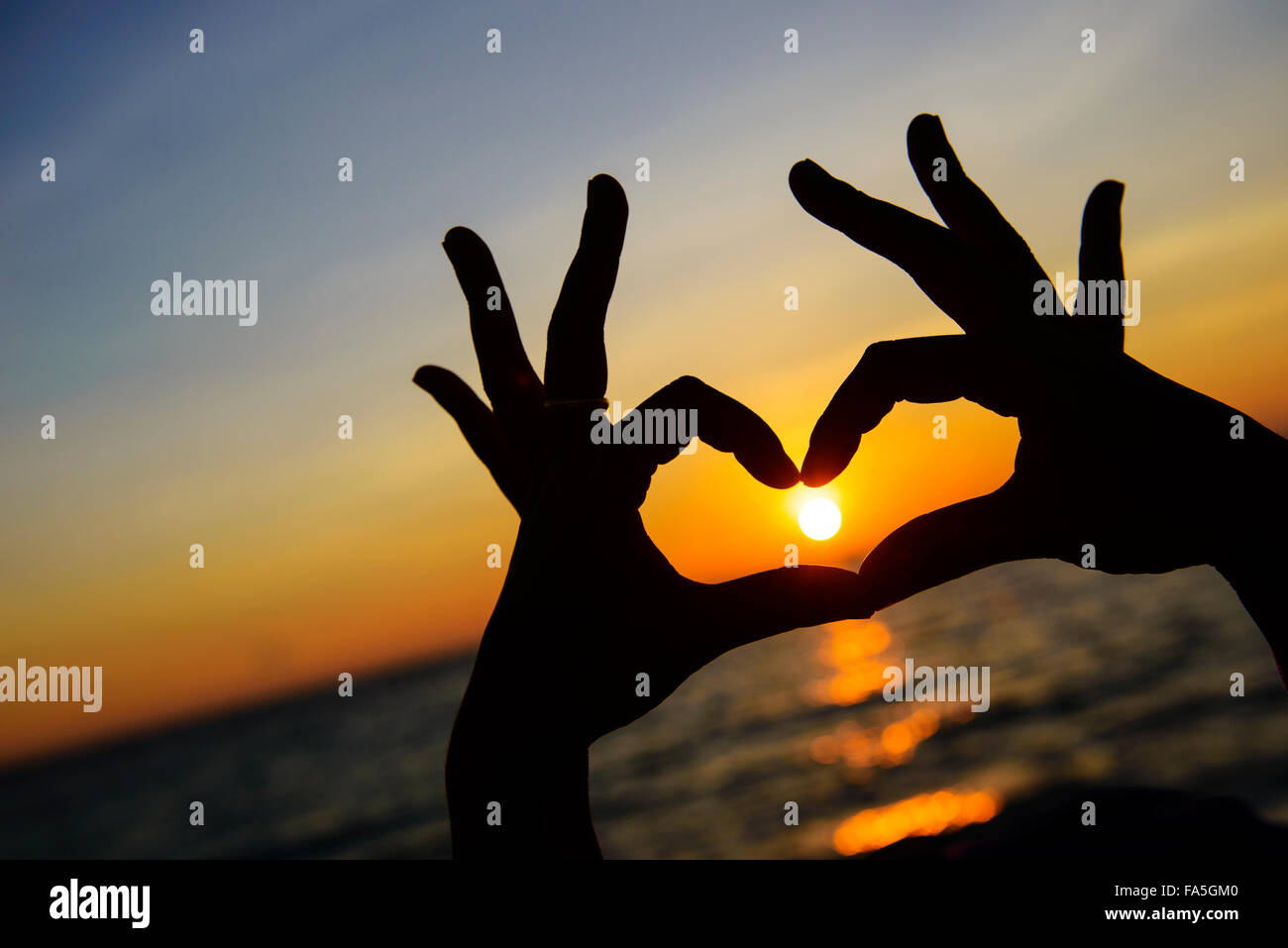 Heart symbol made with hands Stock Photo - Alamy