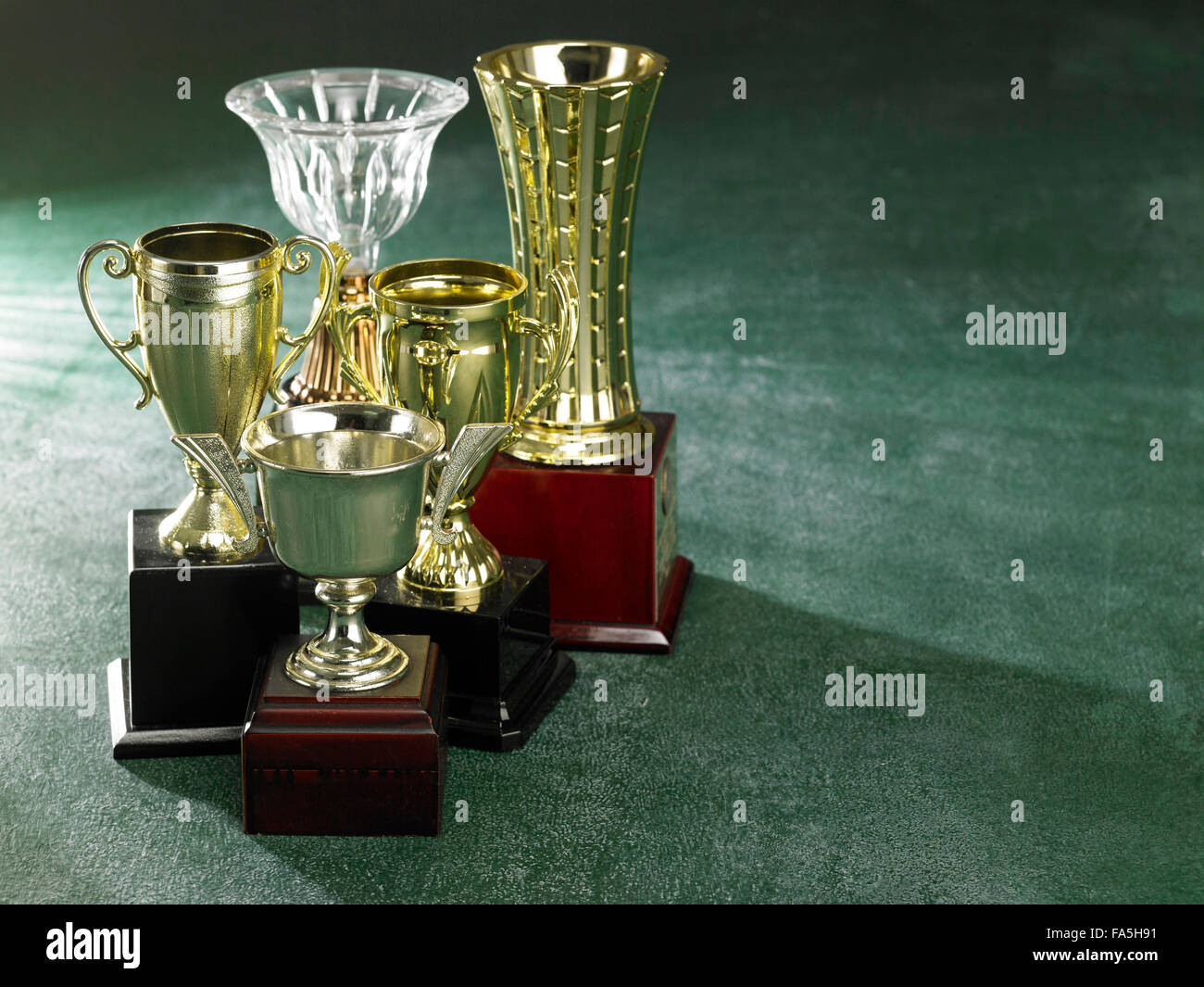 Group of trophy on the green background Stock Photo - Alamy