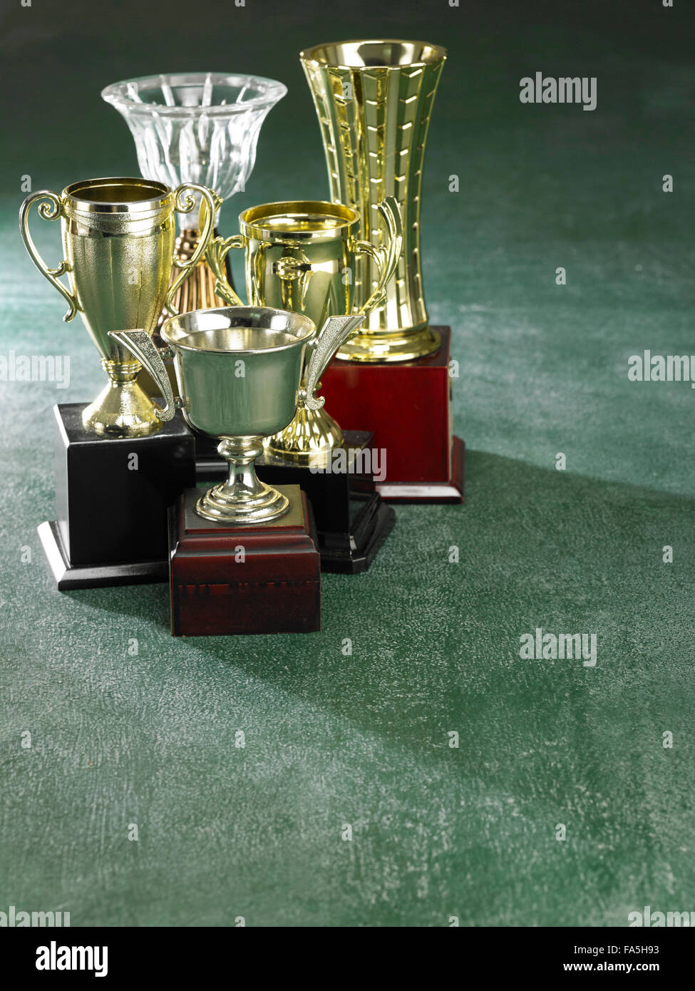 Group of trophy on the green background Stock Photo - Alamy