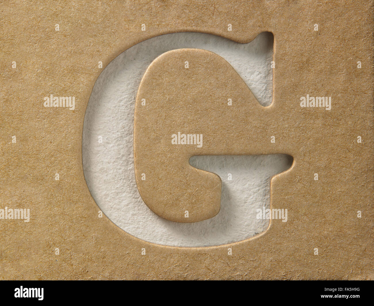 cut out alphabet g on the brown cardboard Stock Photo - Alamy