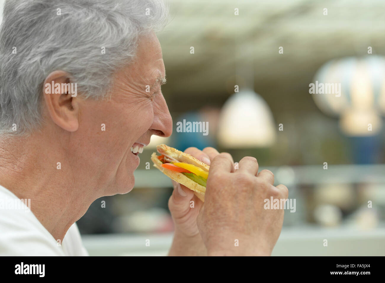 elderly man eating fast food Stock Photo - Alamy