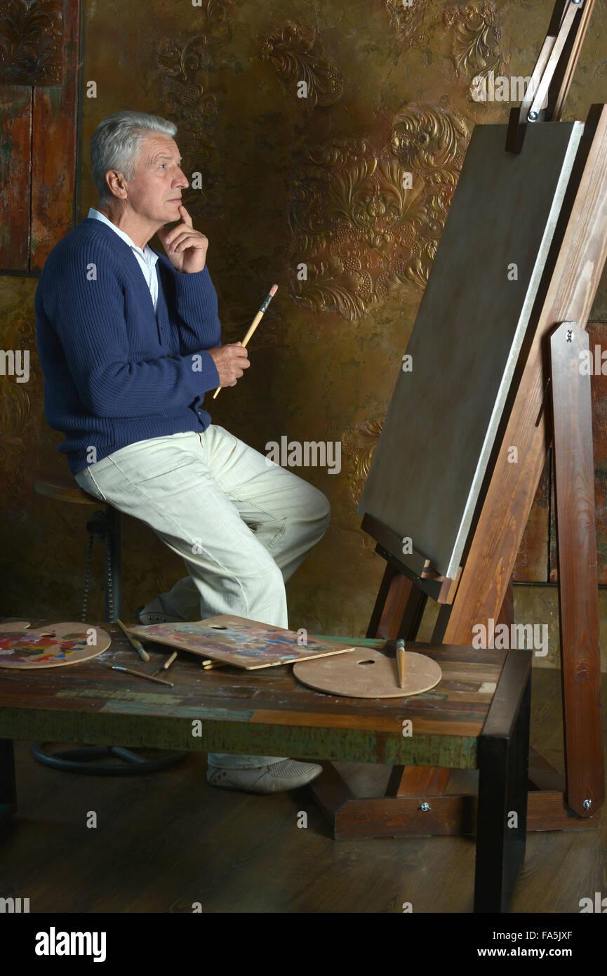 Elderly man painting Stock Photo - Alamy