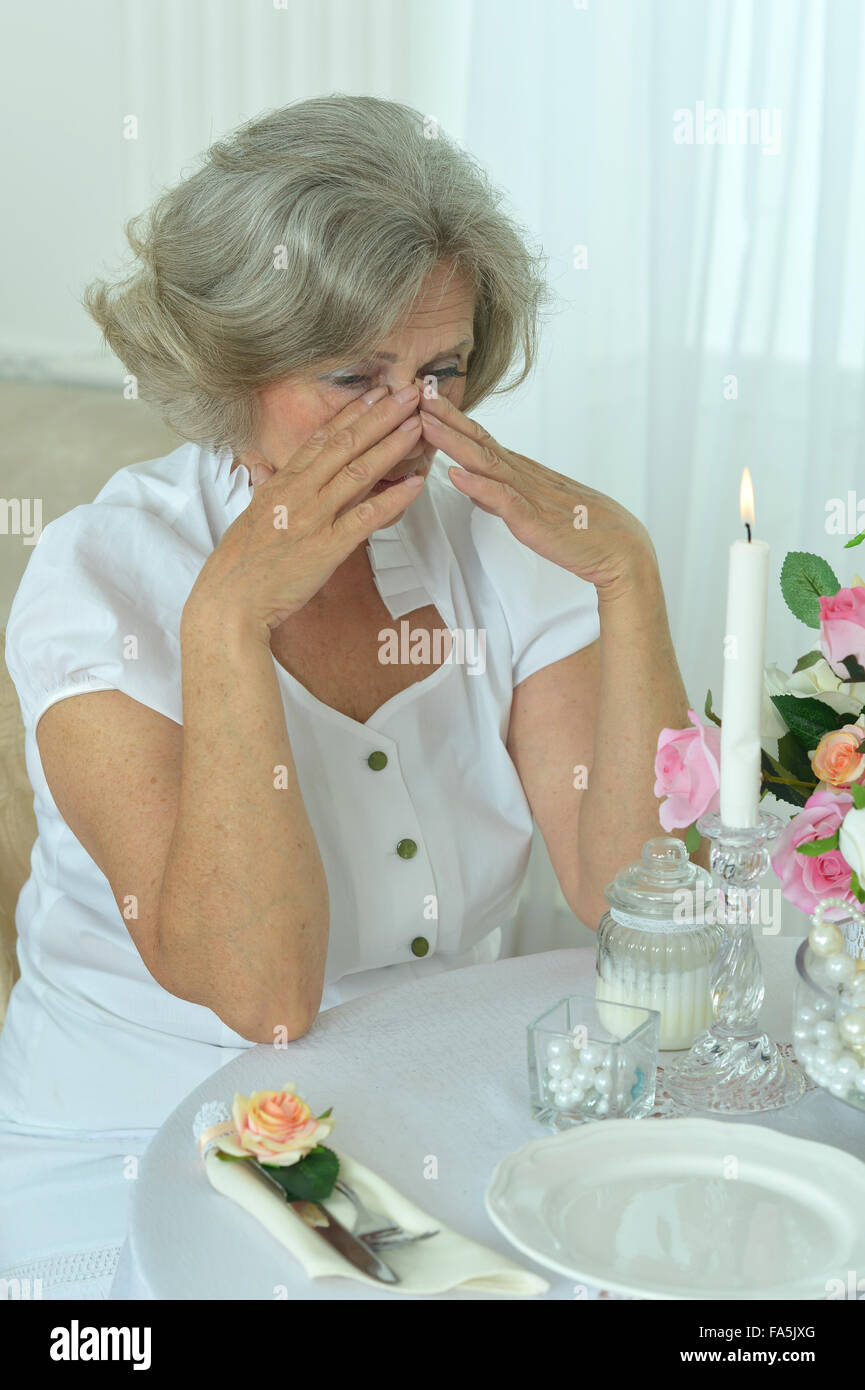 Senior woman crying in room Stock Photo - Alamy