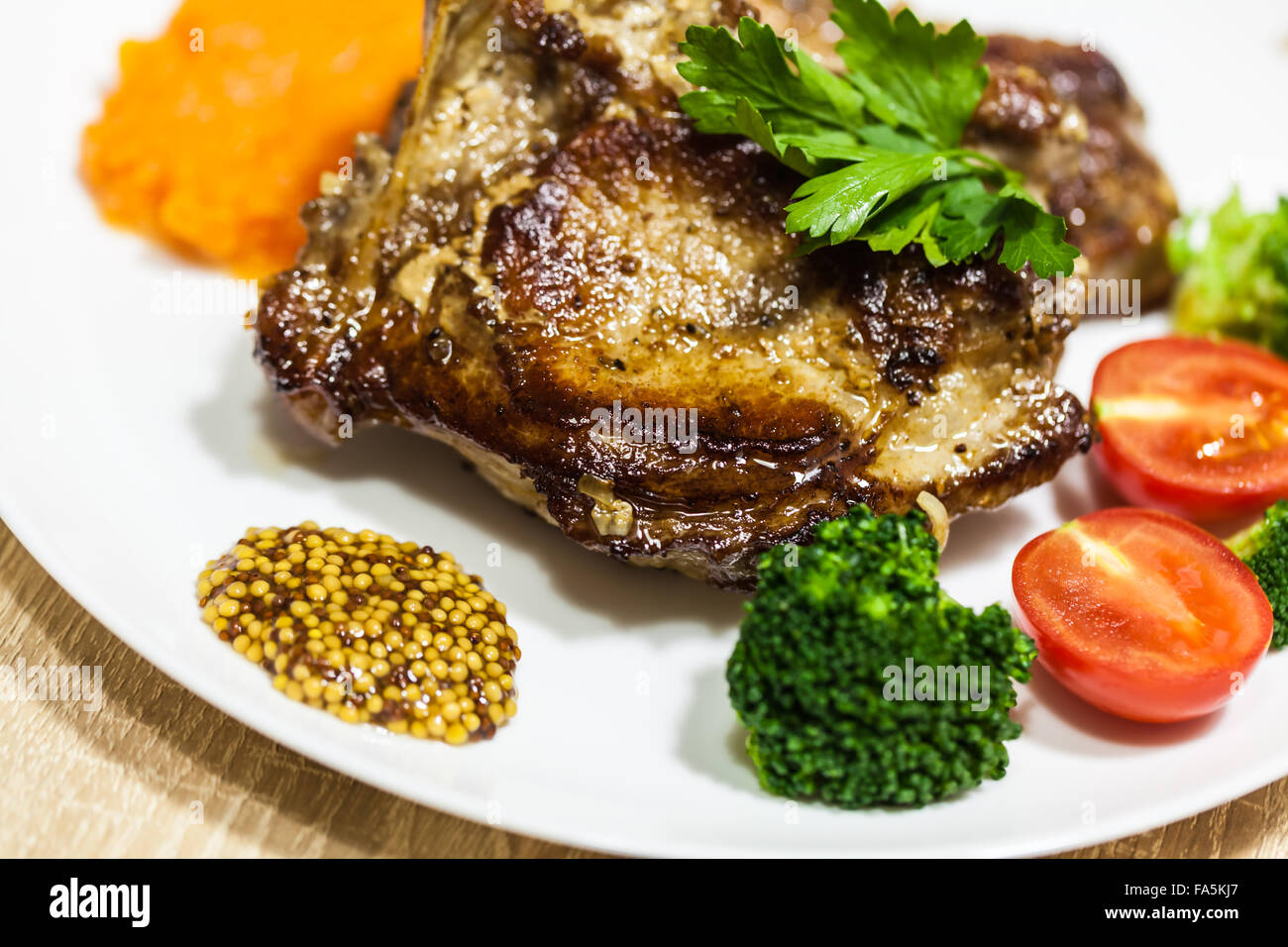 roasted meat with vegetables on a plate closeup Stock Photo - Alamy
