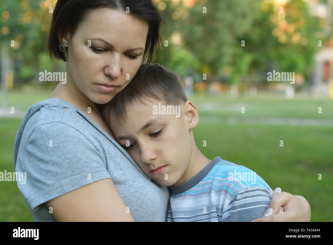 Sad mother with son in park Stock Photo - Alamy