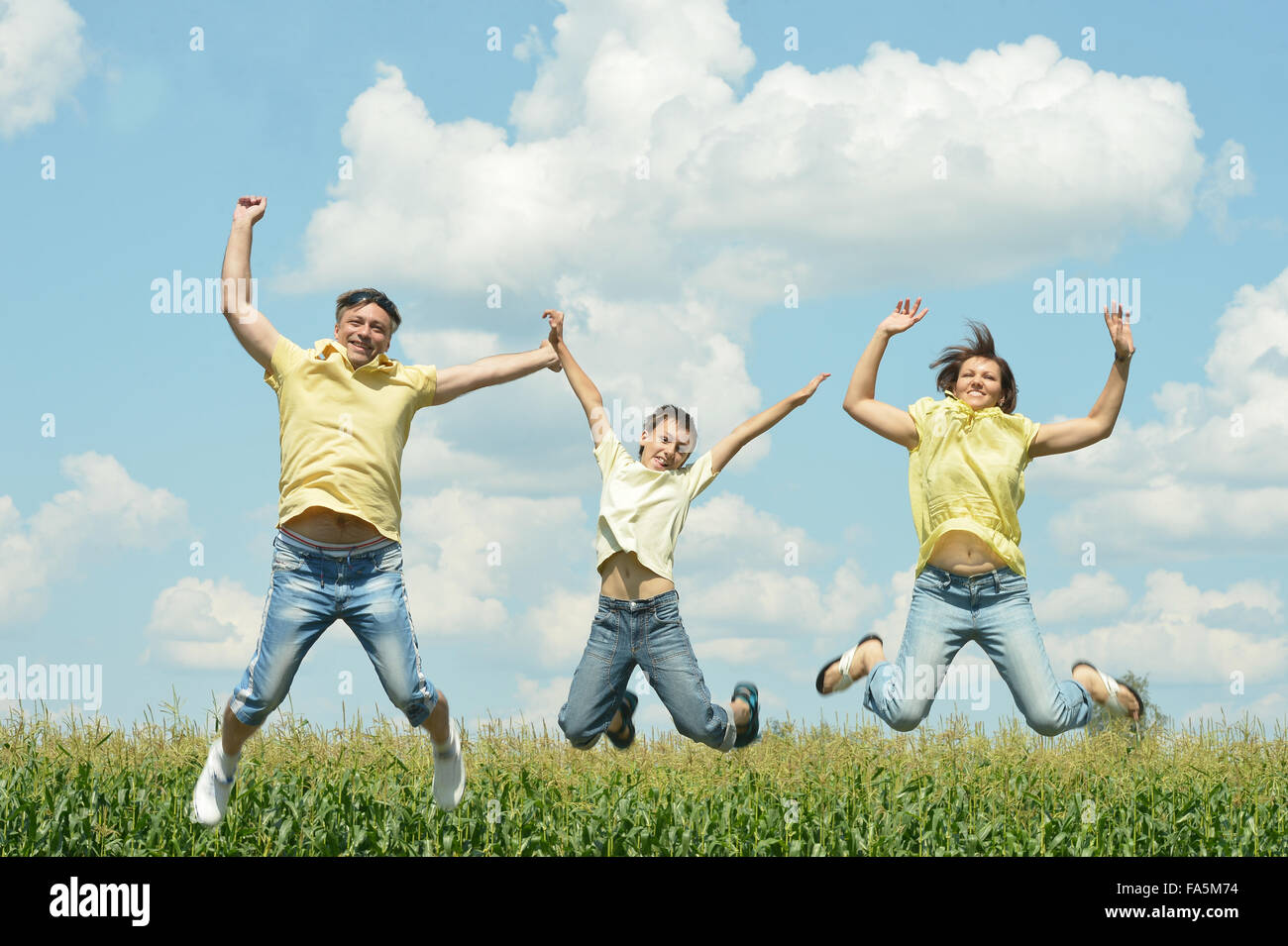 Boy girl jumping grass hi-res stock photography and images - Alamy