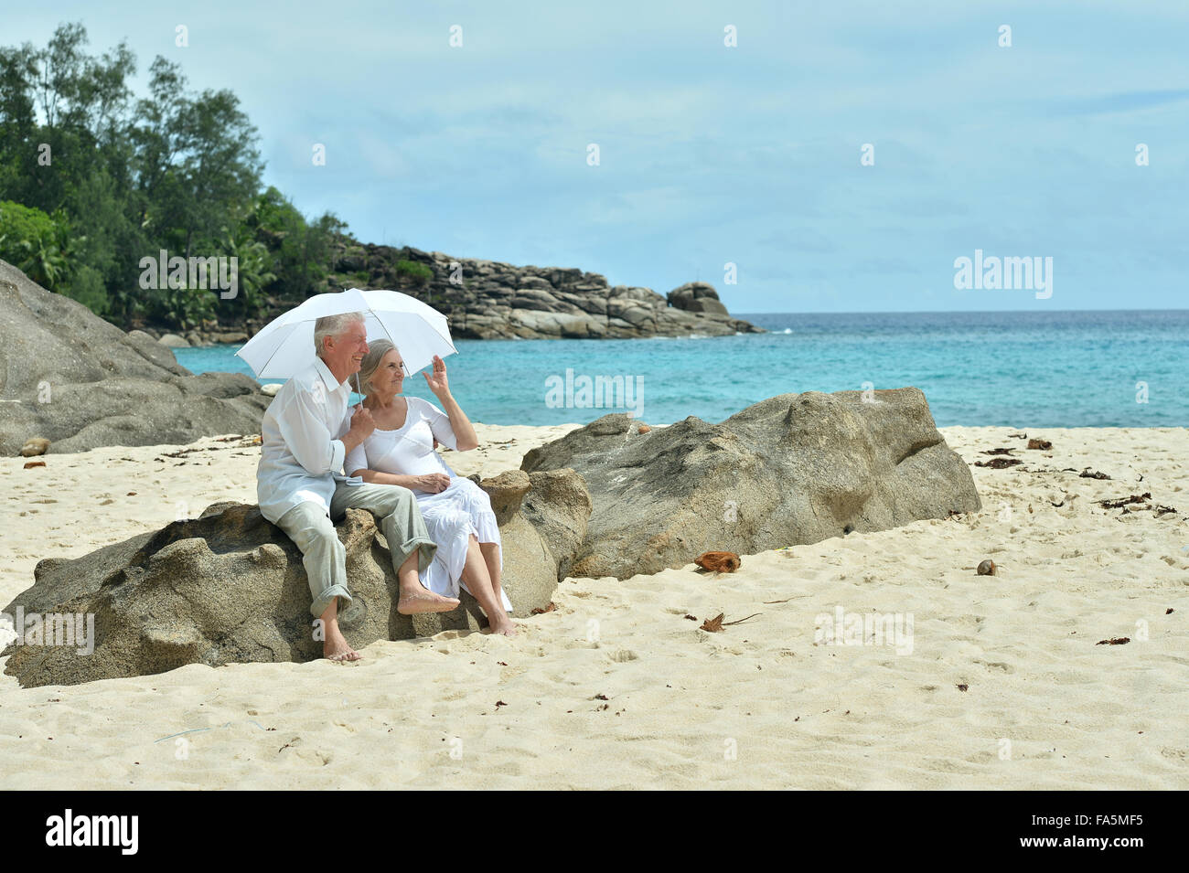 Elderly couple rest at tropical resort Stock Photo - Alamy