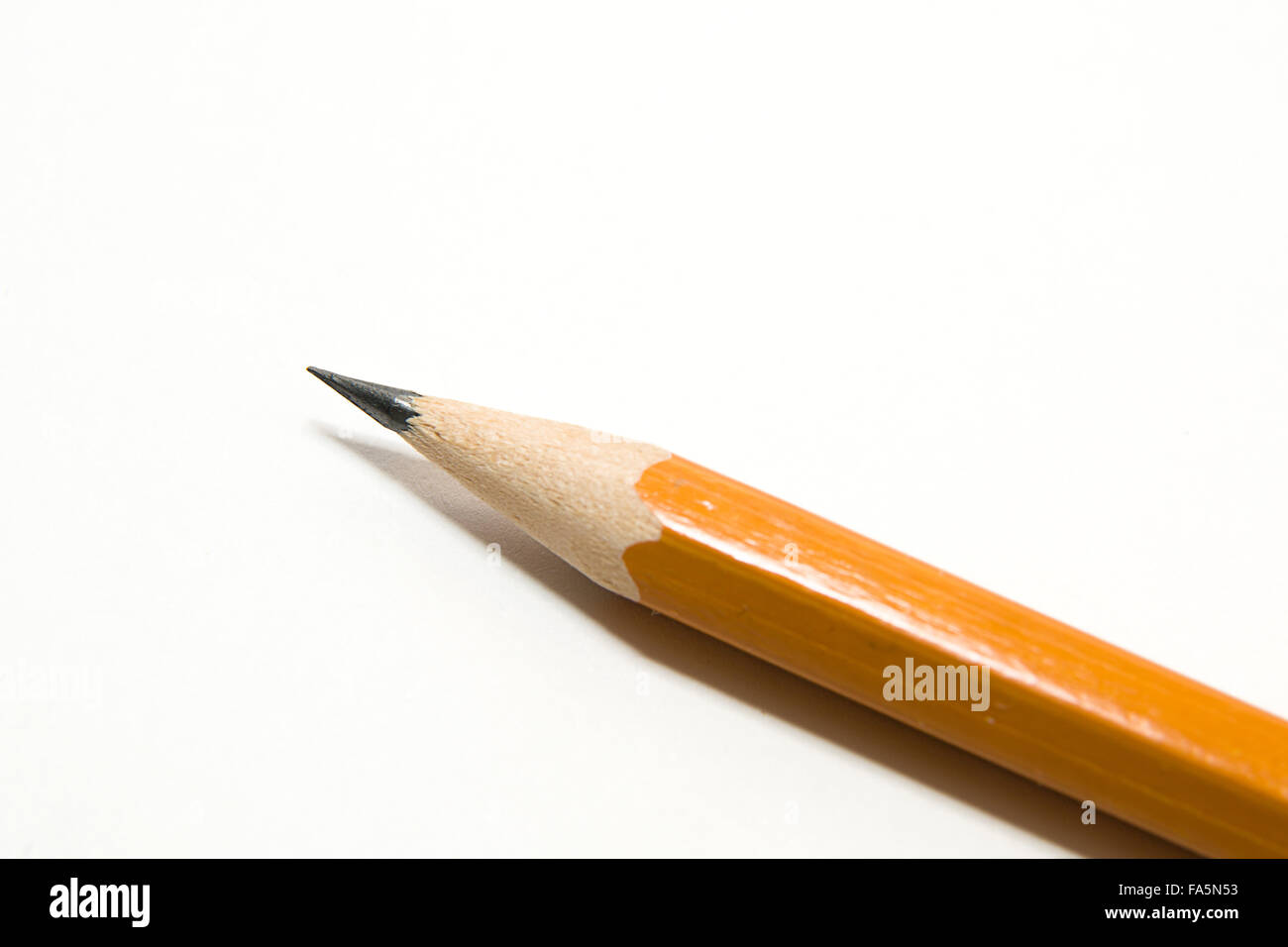 Orange wooden pencil for writing on over white Stock Photo - Alamy