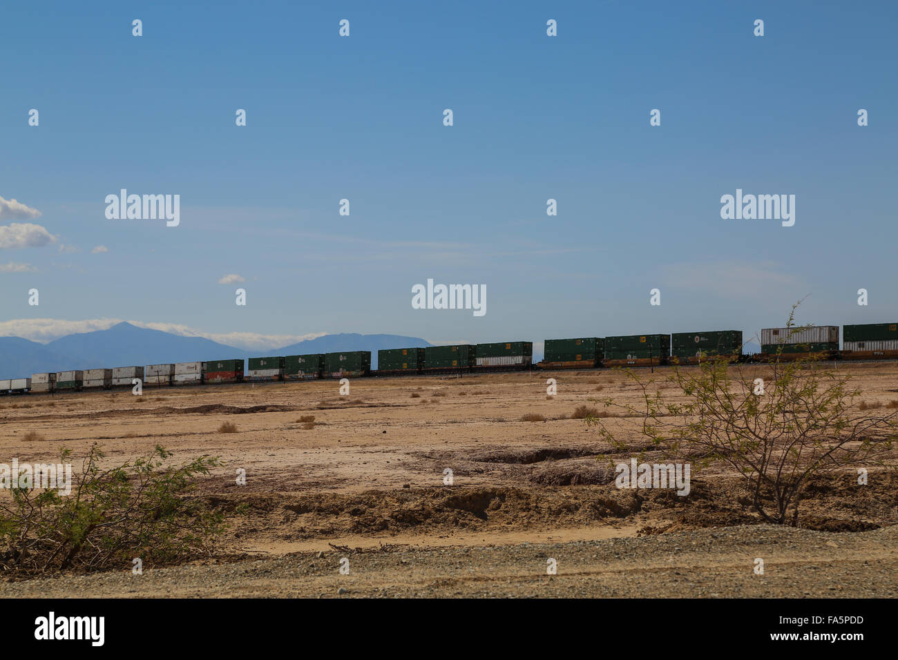 Cargo train moving through the desert in California Stock Photo - Alamy