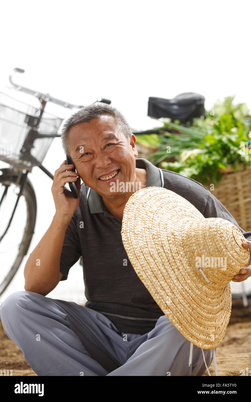 Farmers make a phone call Stock Photo - Alamy