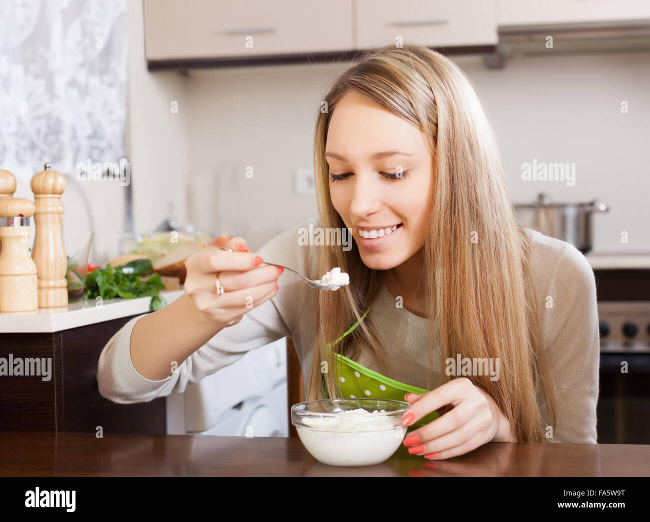 Woman eating cottage cheese hi-res stock photography and images - Alamy