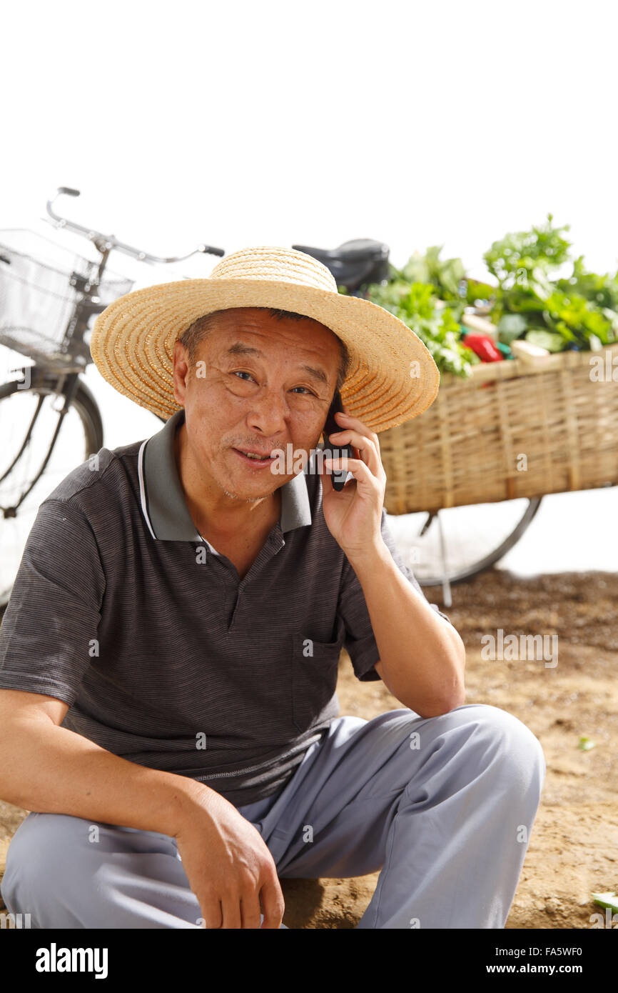 Farmers make a phone call Stock Photo - Alamy