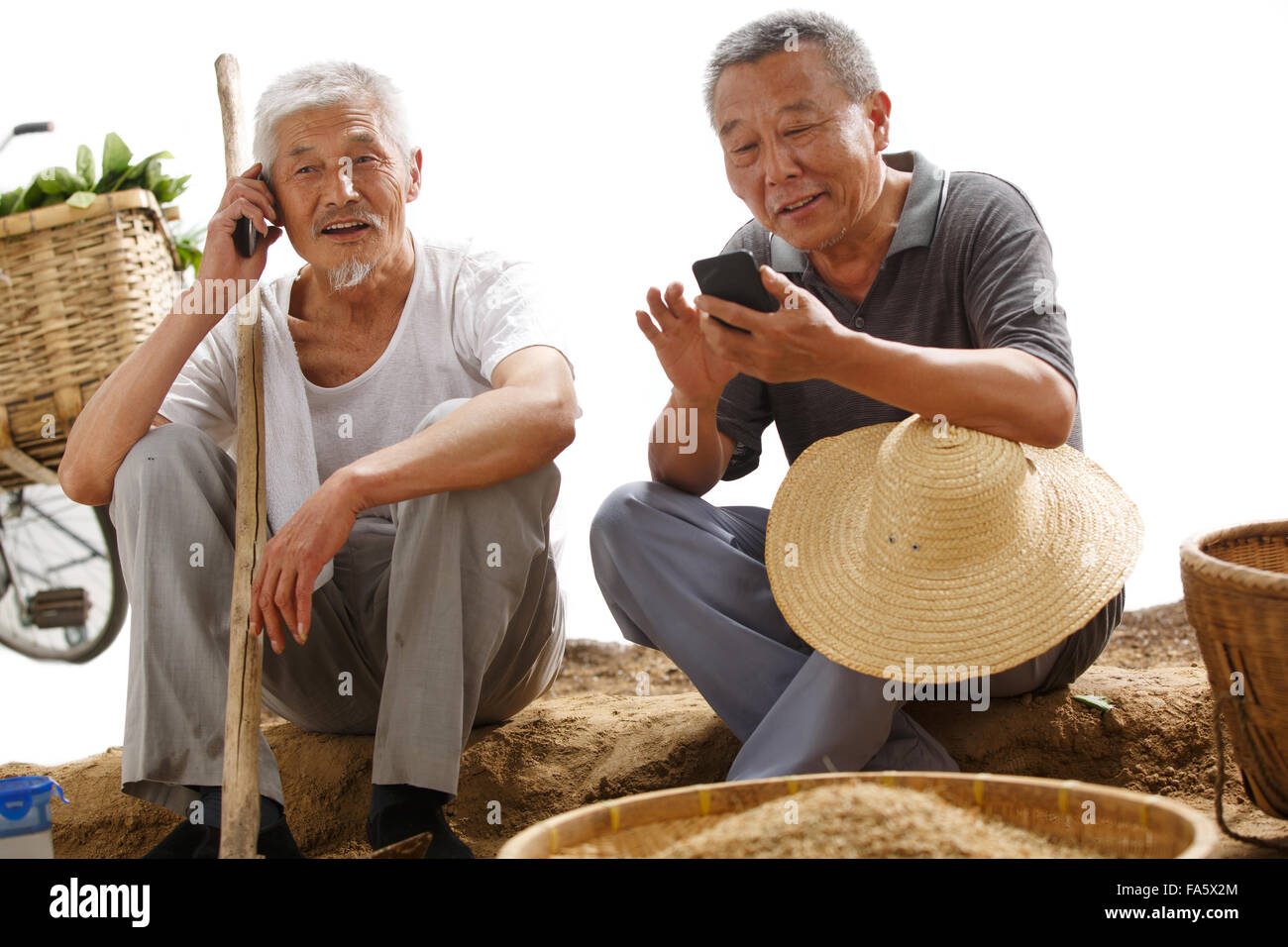 Farmers make a phone call Stock Photo - Alamy