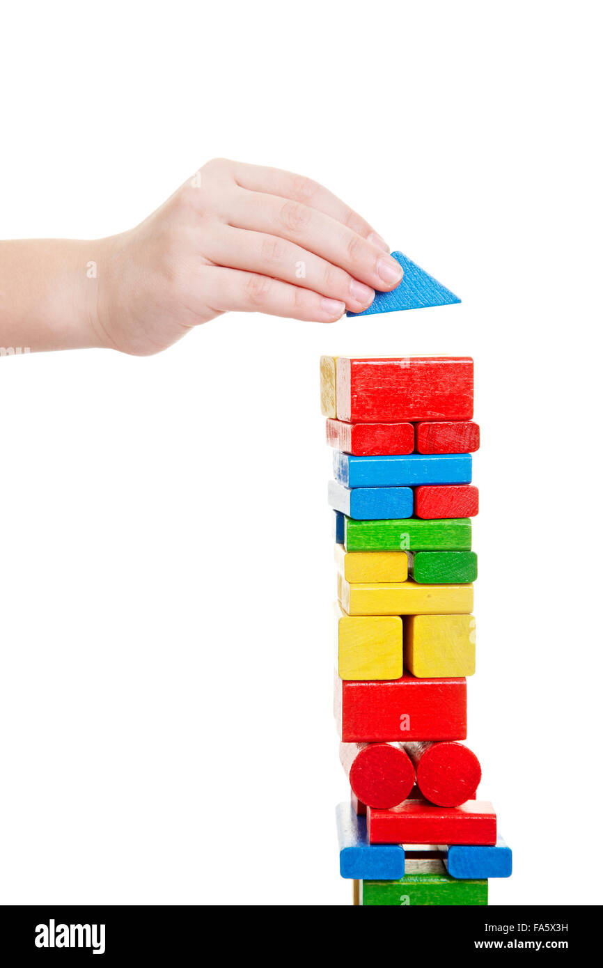 Childrends hand building tower made off building bricks Stock Photo - Alamy