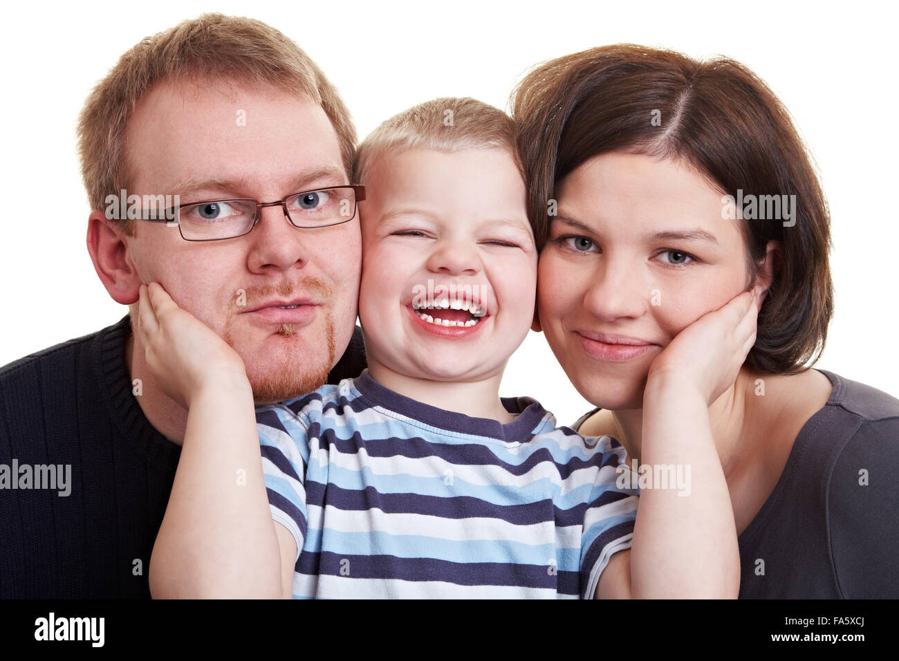 Happy little boy pressing his parents cheeks against his own Stock ...