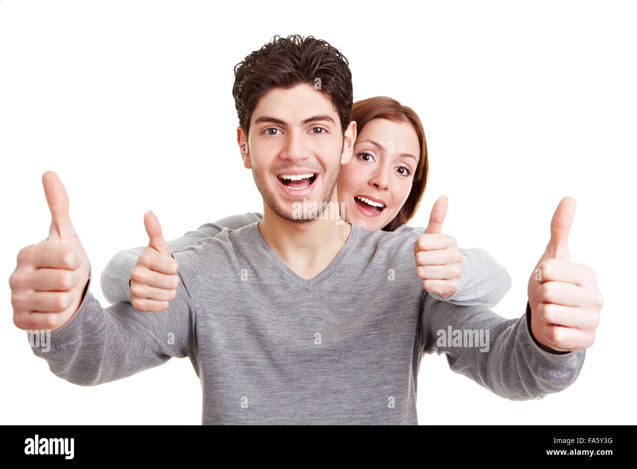 Smiling happy couple holding both thumbs up Stock Photo - Alamy
