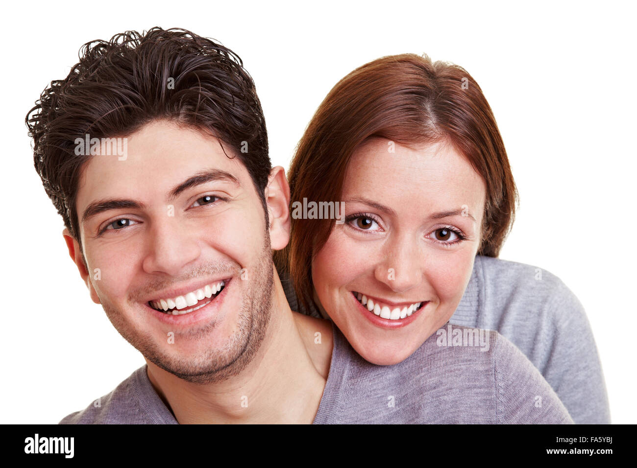 Young happy couple smiling into the camera Stock Photo - Alamy