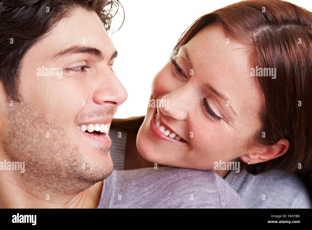 Happy young couple smiling at each other Stock Photo - Alamy