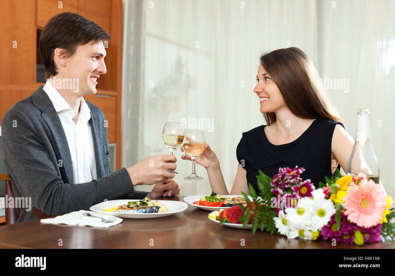 Smiling man and woman having romantic dinner in home Stock Photo - Alamy