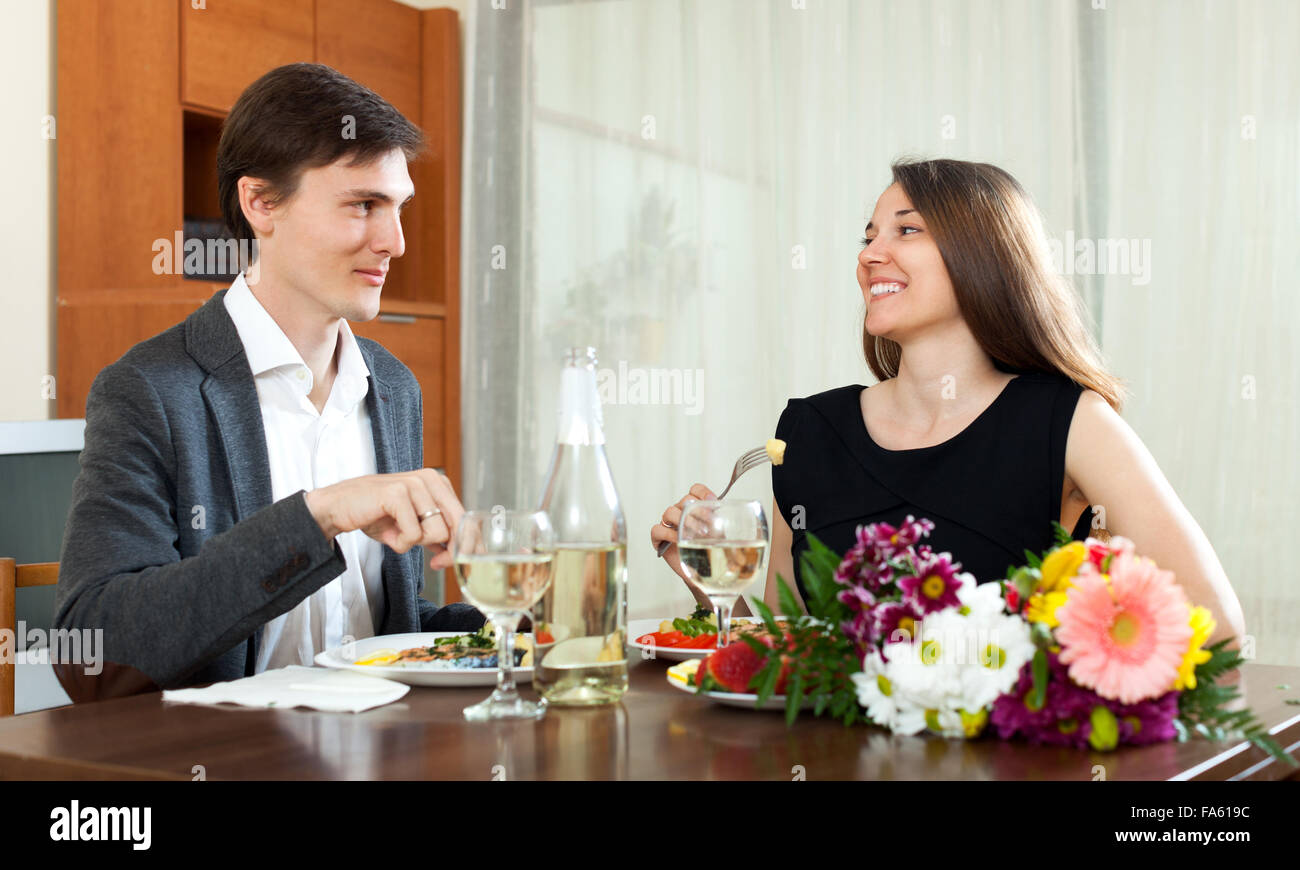 Young smiling man and woman having romantic dinner in home Stock Photo ...