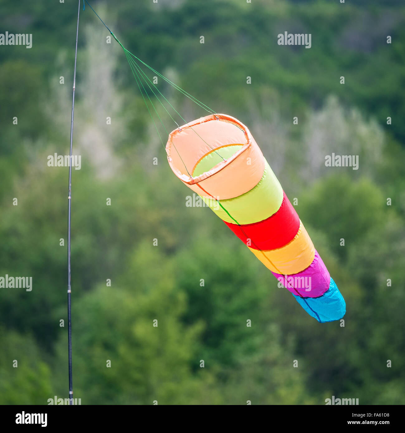 The colorful wind vane on the green background Stock Photo - Alamy