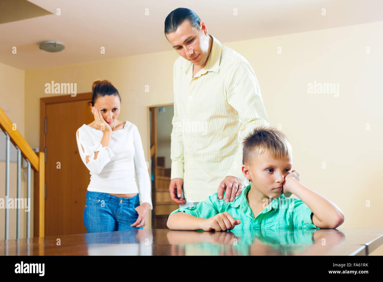 Parents scolding teenager son in home. Focus on boy only Stock Photo ...